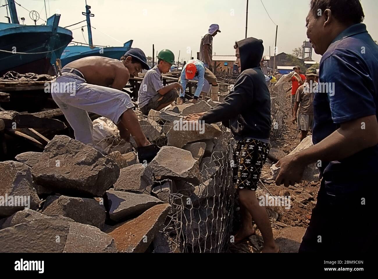 Residents of Muara Baru village in Jakarta coastal area working ...