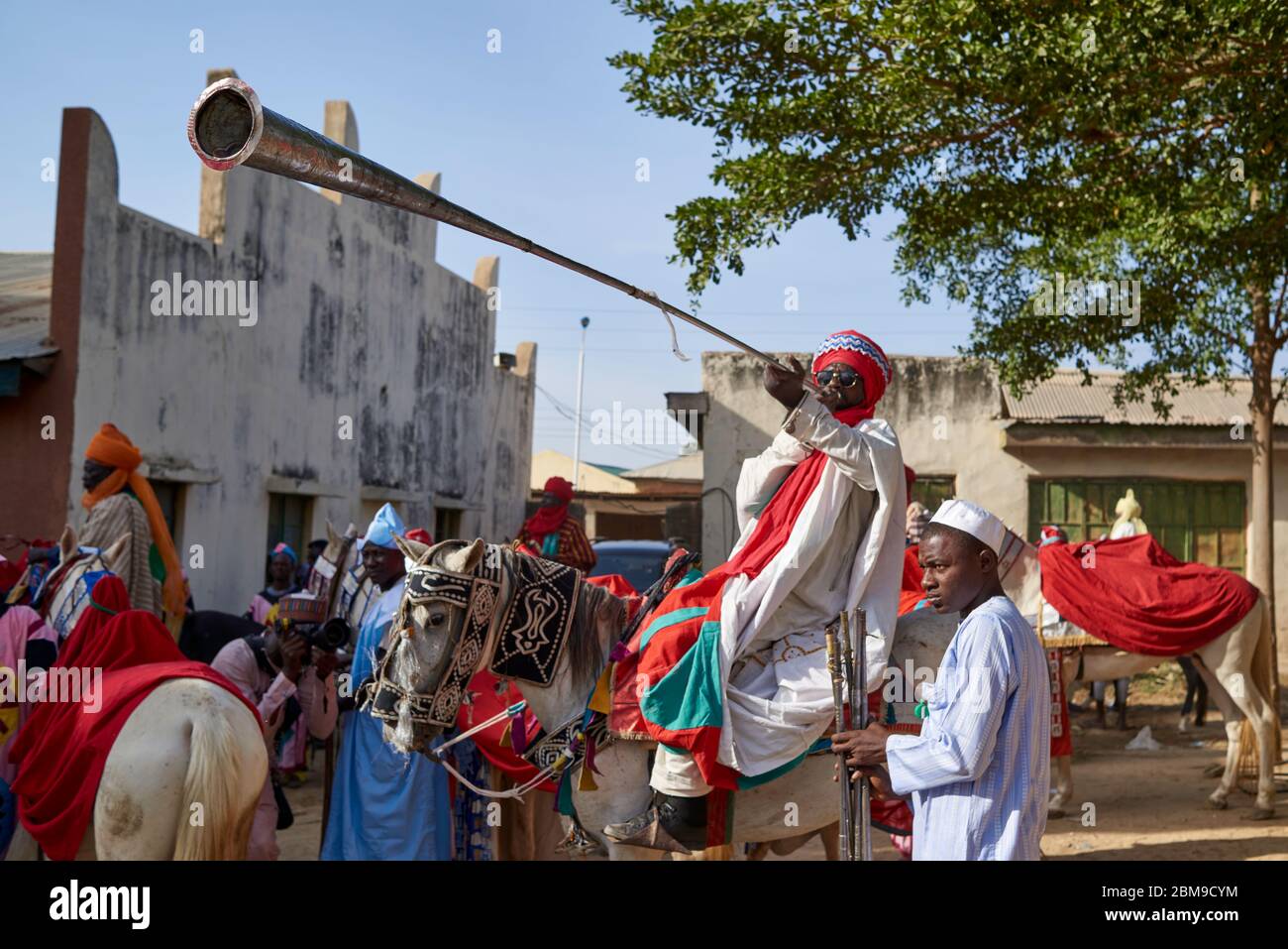 Musician playing traditional Nigerian trumpet during the celebration of ...