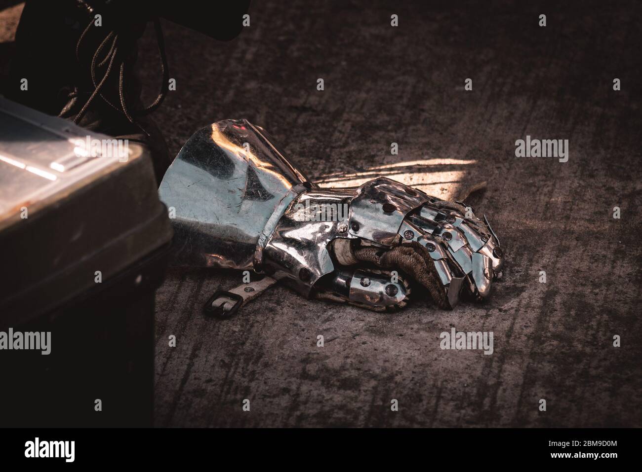 Silver metal gauntlets thrown in the floor full of scratches due to ...