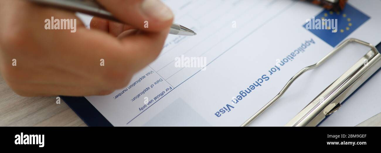 Man writing down personal information Stock Photo - Alamy