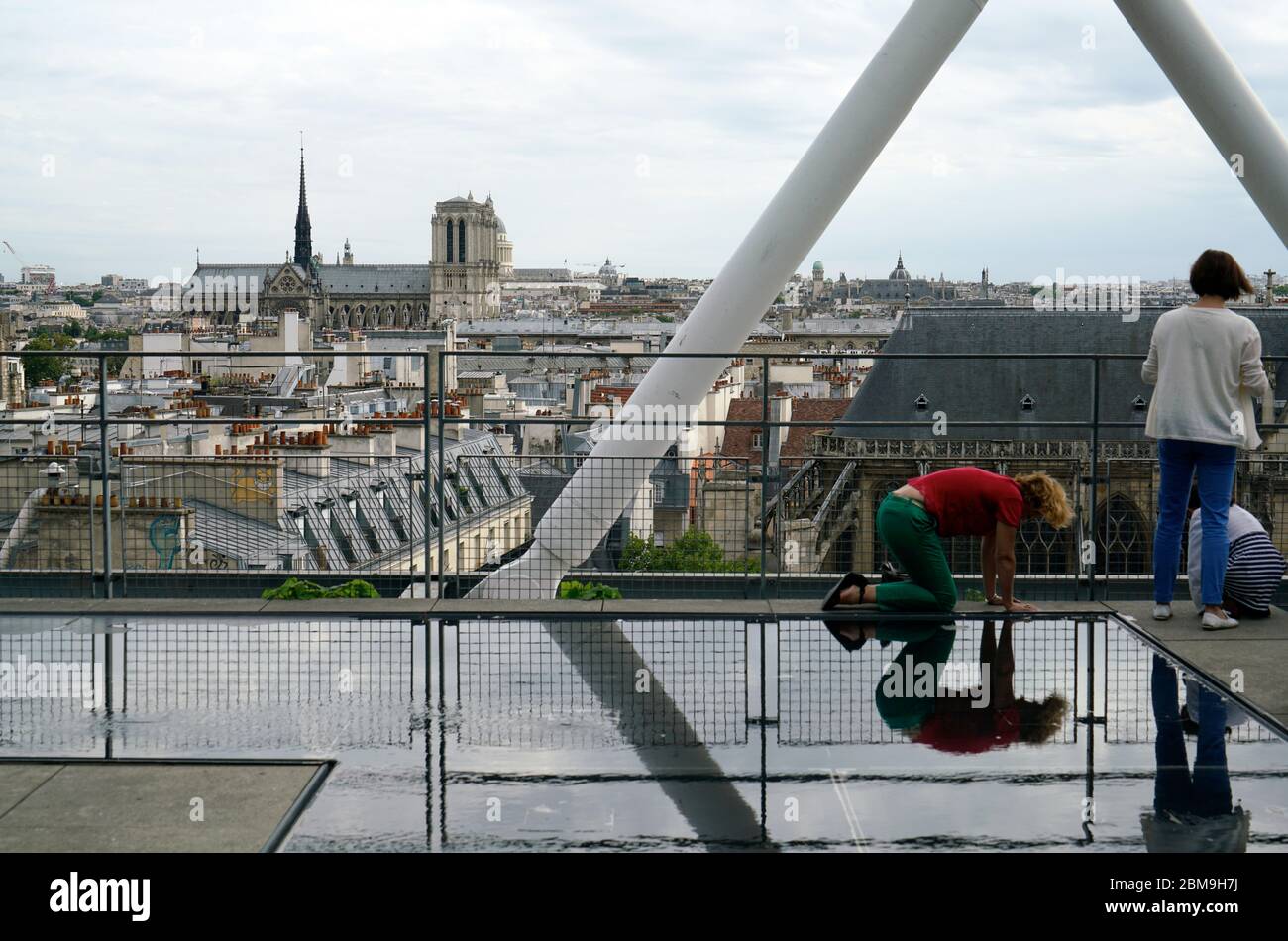 The rooftop view city of Paris and Notre-Dame Cathedral in distance ...