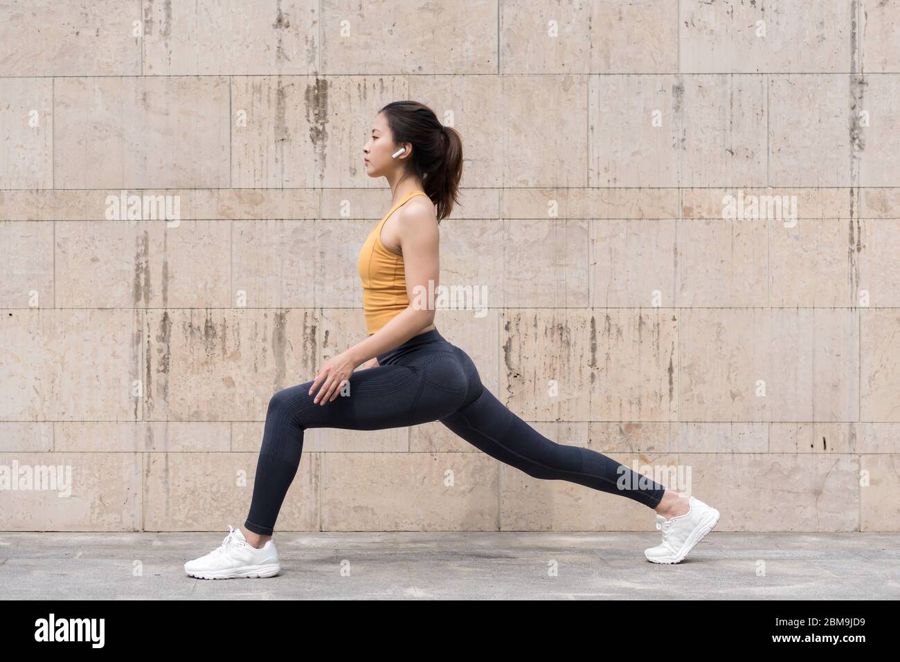 A young Asian woman is doing warm-up exercises Stock Photo - Alamy
