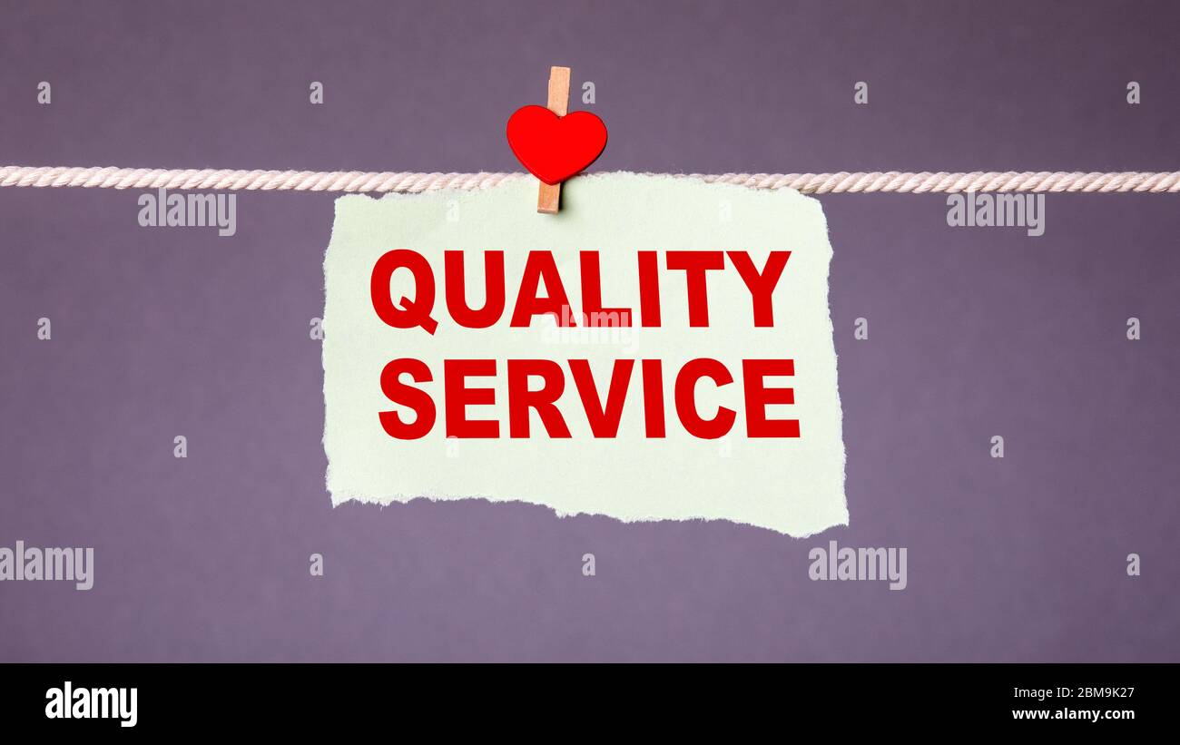QUALITY SERVICE concept. Sheet attached with peg on the rope ...