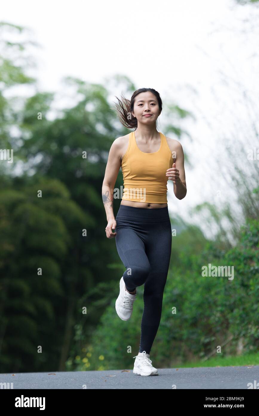 Asian woman jogging workout alone hi-res stock photography and images ...