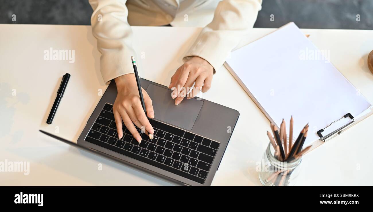 Top view image of businesswoman's hands typing on computer laptop that ...