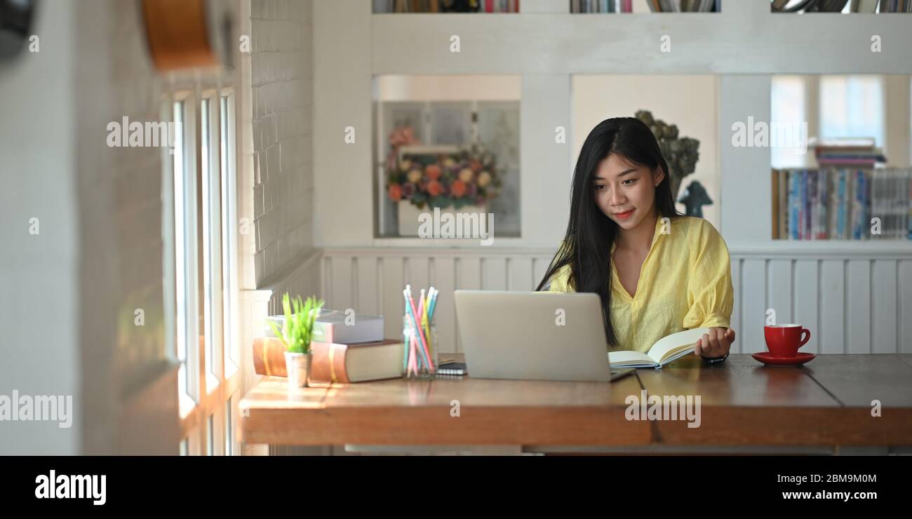 Photo of woman sitting and taking note while sitting in front her ...