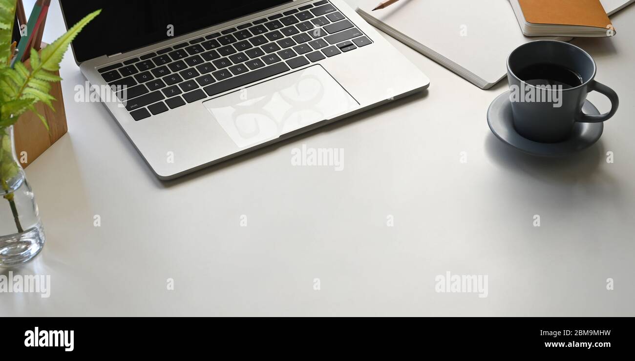 Photo of computer laptop putting on white working desk and surrounded ...