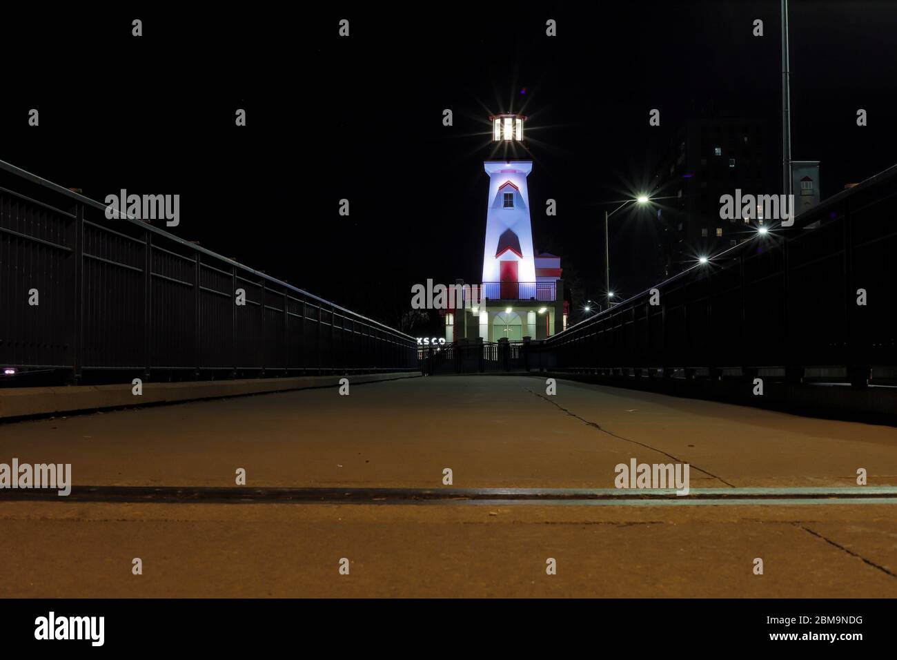 Night time. Old working lighthouse and bridge Stock Photo - Alamy