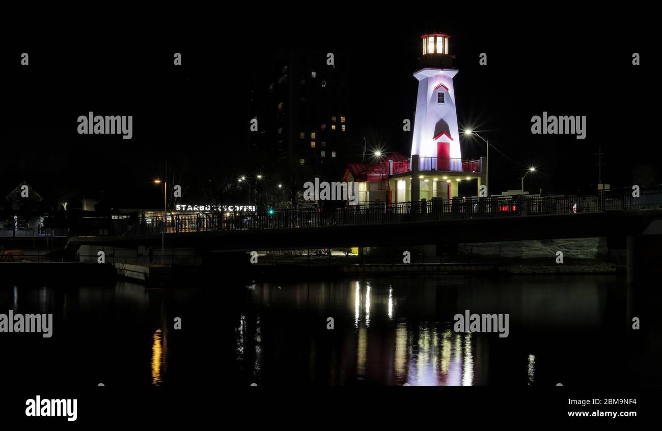 Night time. Old working lighthouse and bridge Stock Photo - Alamy