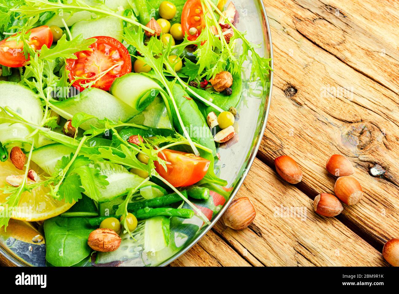 Spring green salad with vegetables and nuts.Diet menu Stock Photo - Alamy