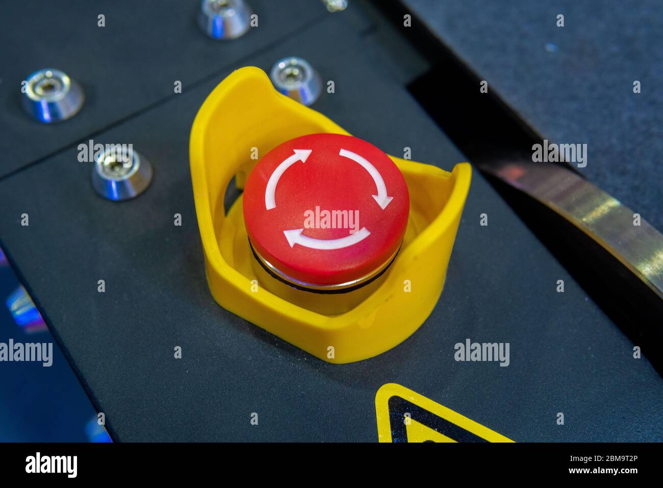 Red emergency button with arrows on black panel Stock Photo - Alamy