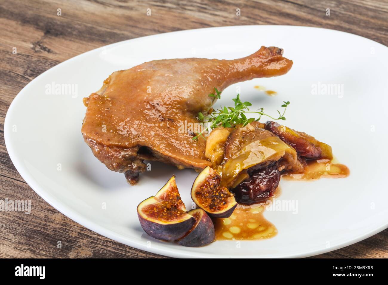 Roasted. duck. leg with plum, fig and apple Stock Photo - Alamy