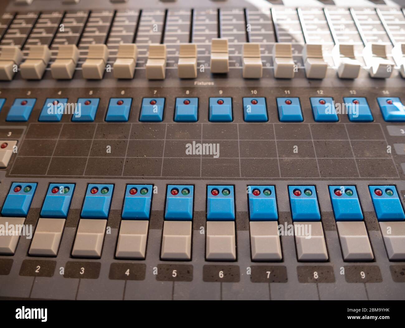 Sound mixer control panel with sliders and buttons closeup view ...