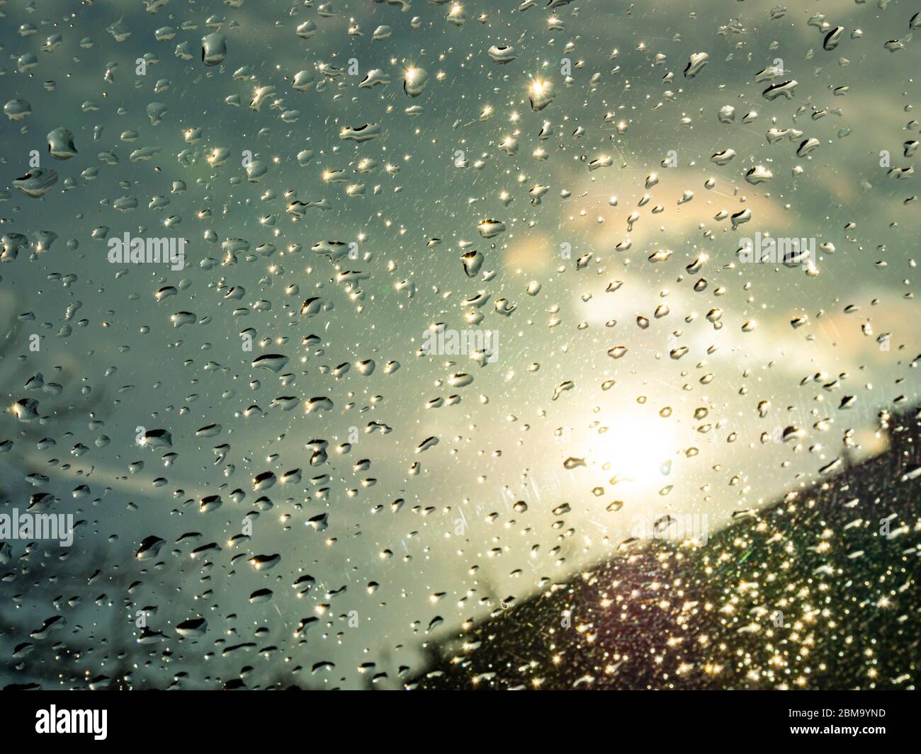 Wet window with rain drops and a cloudy sky outside background Stock ...
