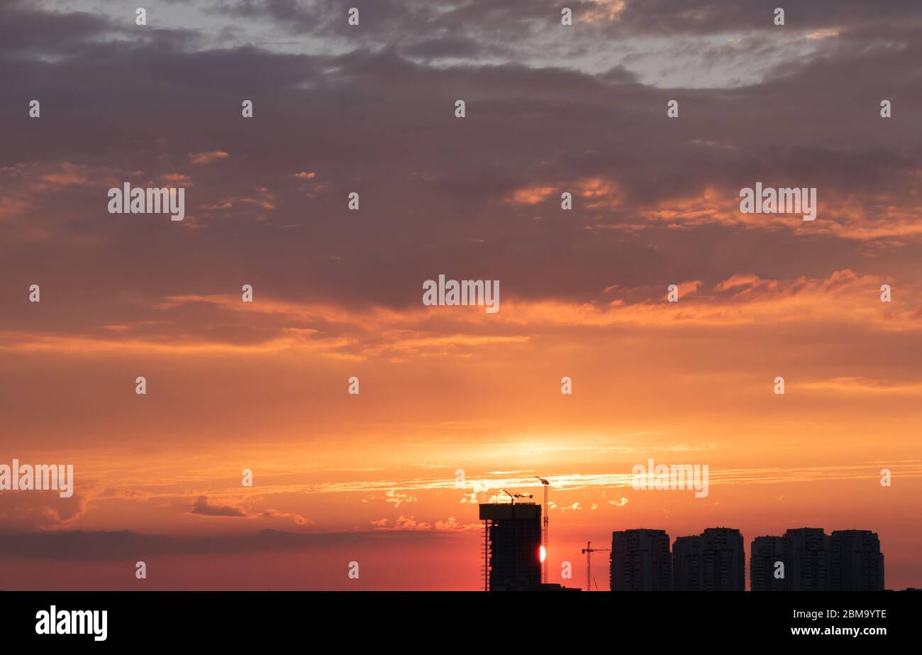 Construction Tower and sky-scraper building and crane against colorful ...