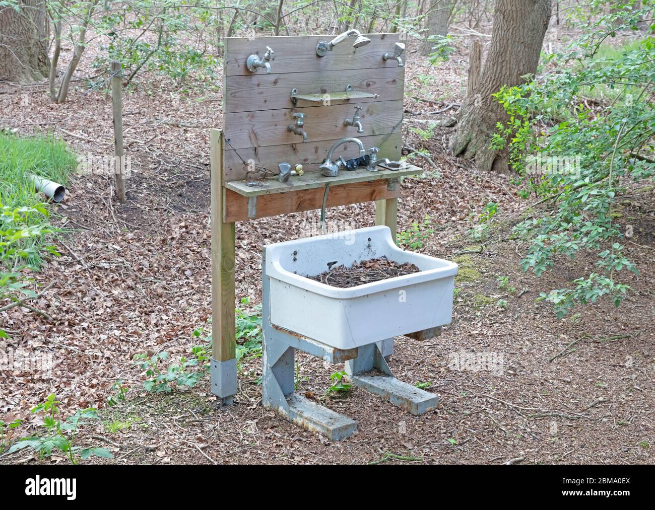 Funny tap faucet, in the middle of the forest Stock Photo - Alamy