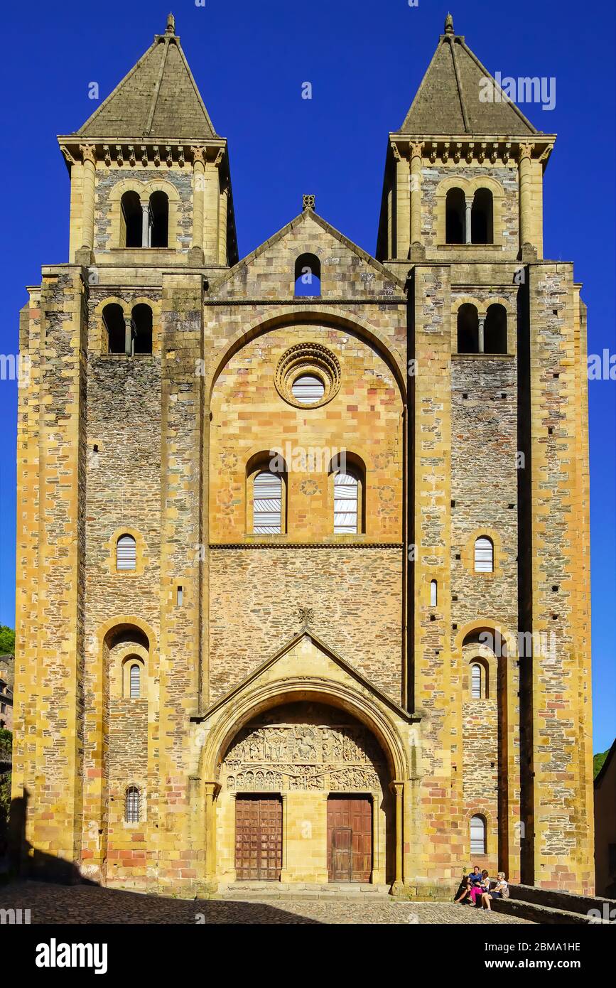 West facade of Romanesque abbey Sainte-Foy in Conques, France Stock ...