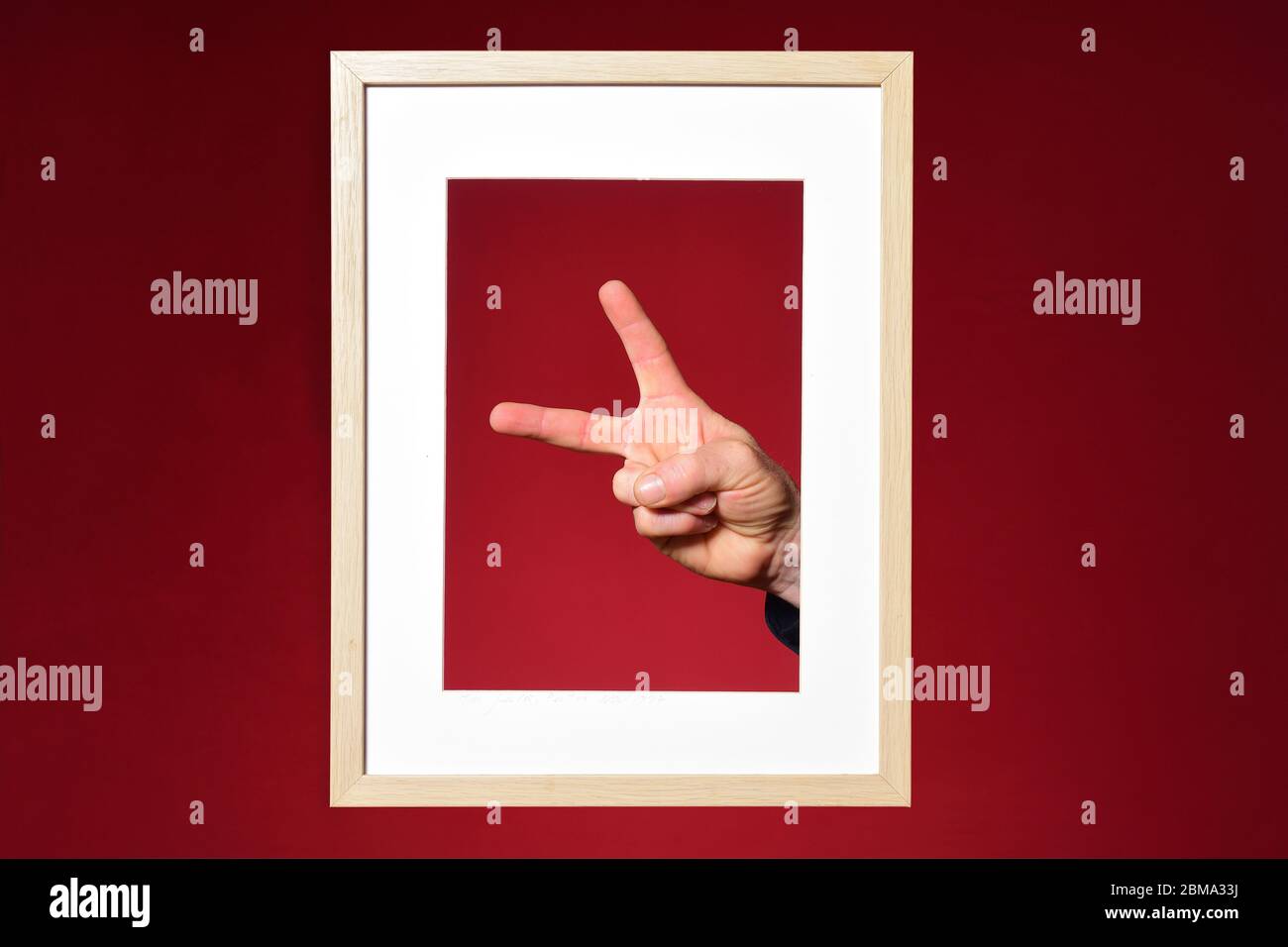 hand of victory sign on red background Stock Photo - Alamy