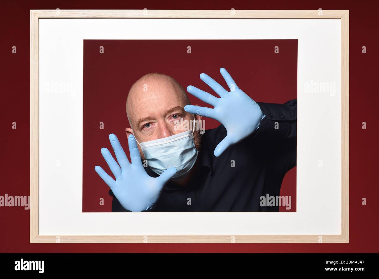 picture of man with gloves and mask with open hands on a red background ...