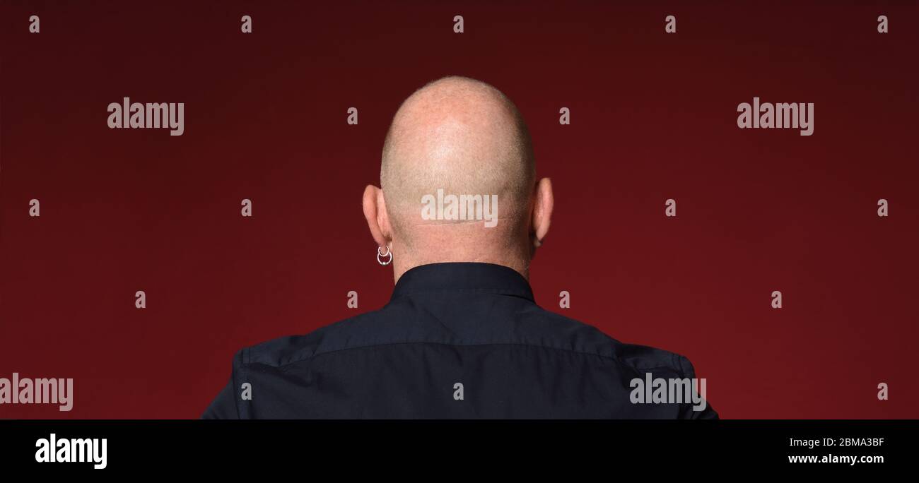 portrait of a bald man,rear view,on red background Stock Photo - Alamy