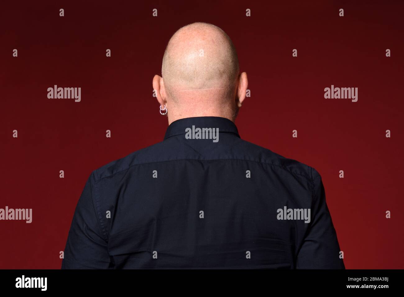 portrait of a bald man,rear view,on red background Stock Photo - Alamy
