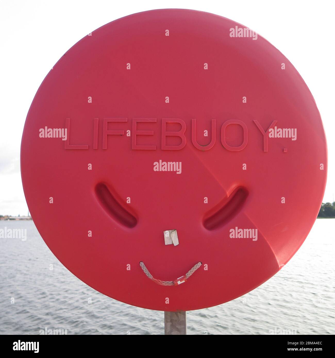 Red plastic lifebuoy on harbor quey in Southern denmark Stock Photo - Alamy