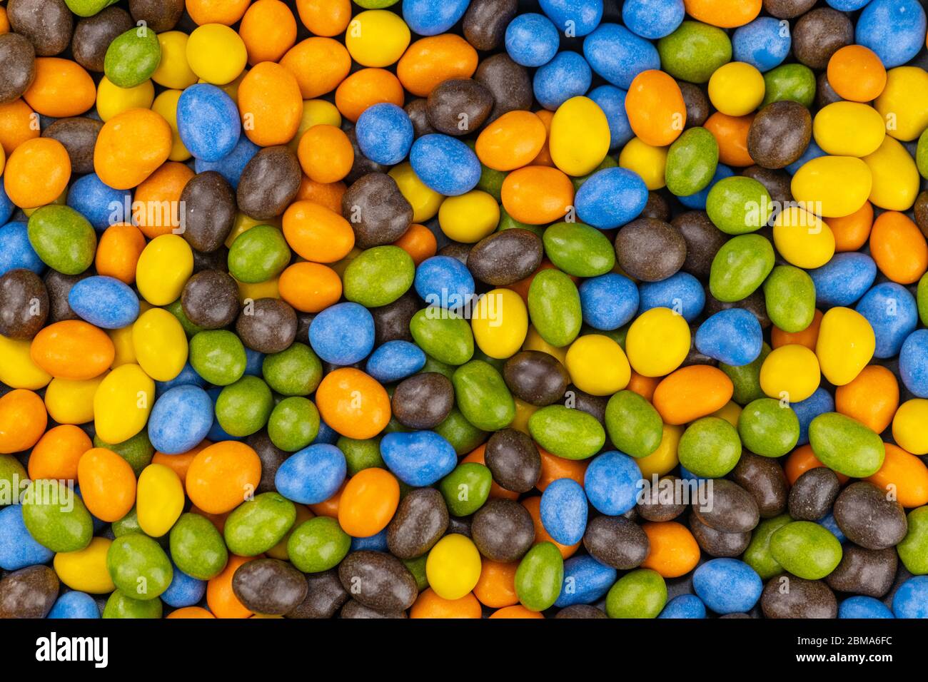 Chocolate coated peanuts as detailed close up shot (selective focus ...