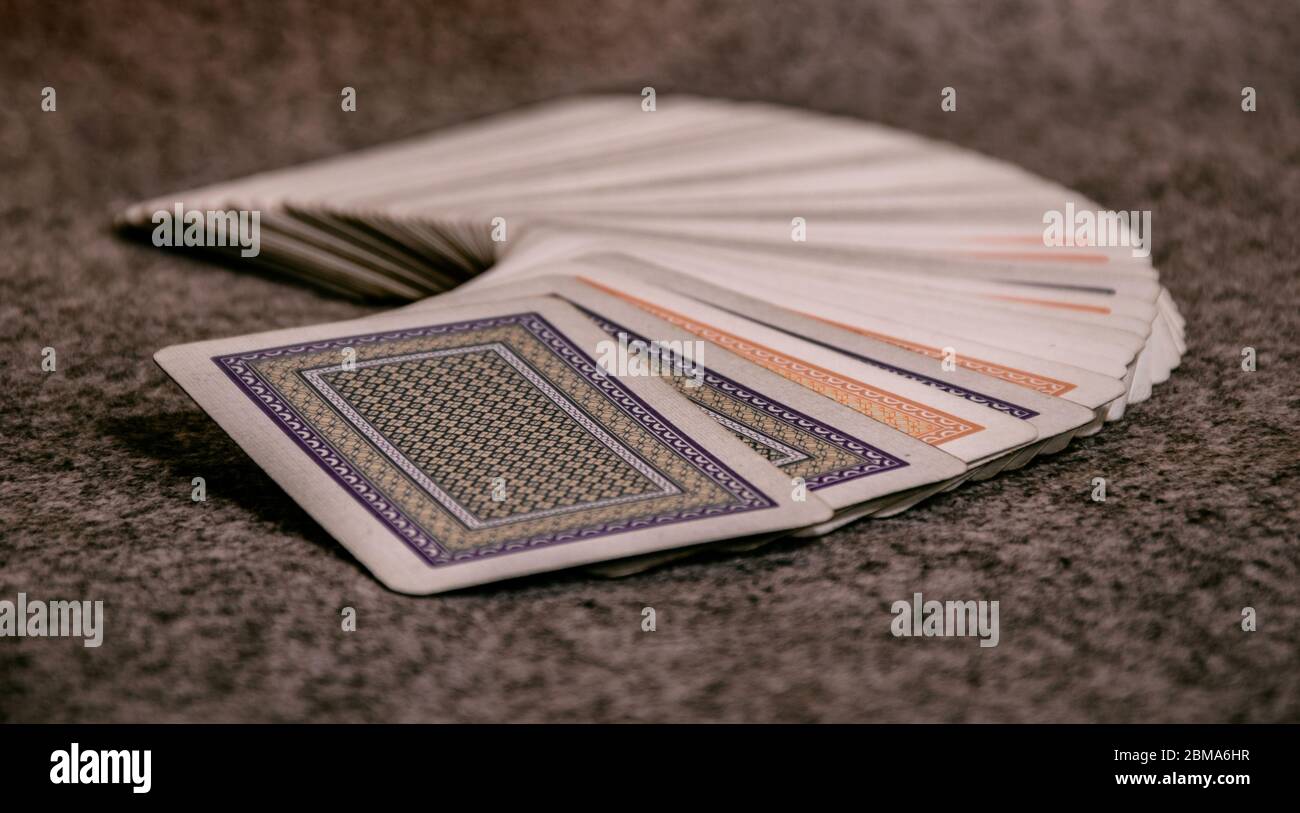 a set of old, used playing cards placed on the table upside down, blue ...
