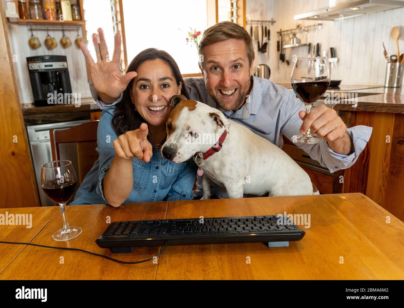 Screen view of Happy couple and pet dog video calling friends using ...
