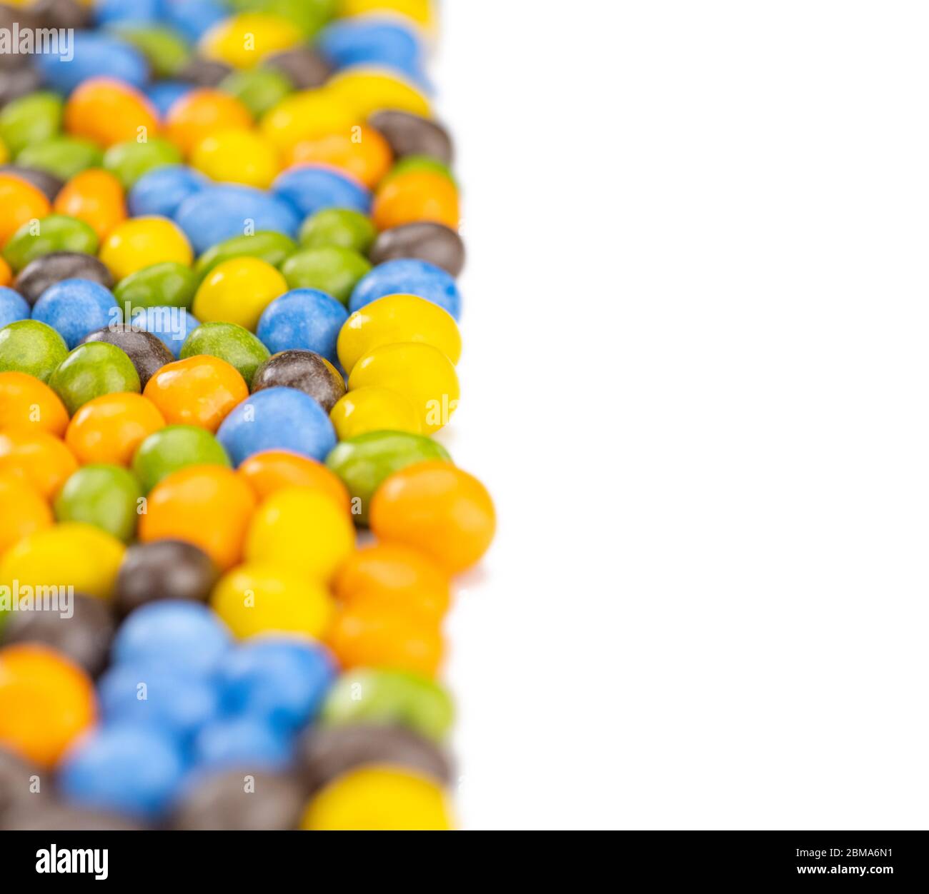 Chocolate coated peanuts isolated on white background (selective focus ...