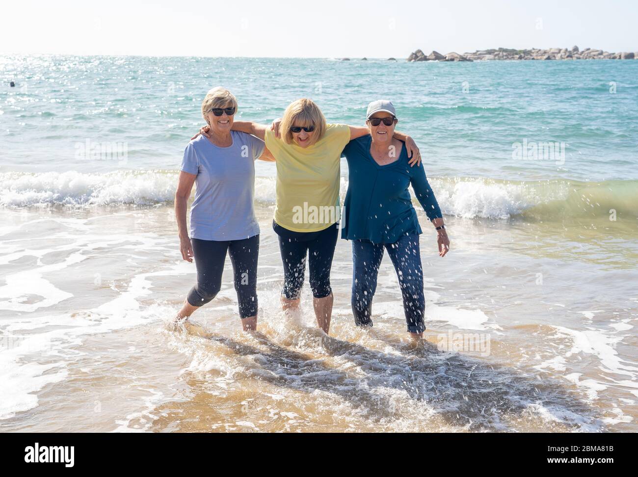 Happy mature woman walking water beach hi-res stock photography and ...