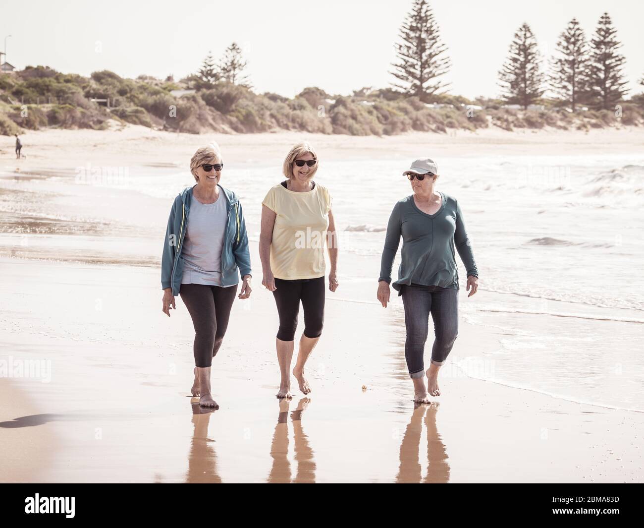 Group of three senior retired woman from elderly home walking together ...