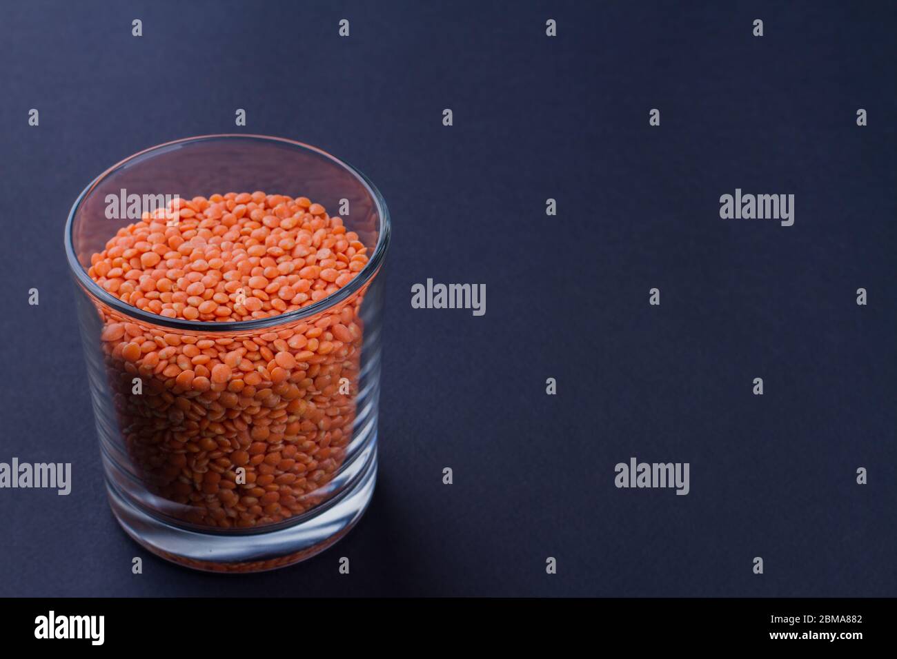 Glass cup full of orange lentils Stock Photo - Alamy