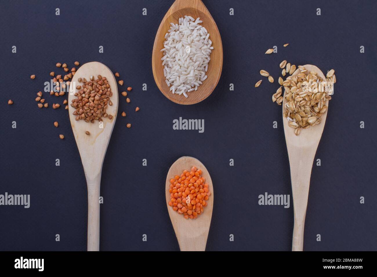 Rustic vintage wooden spoons with four types of grains Stock Photo - Alamy