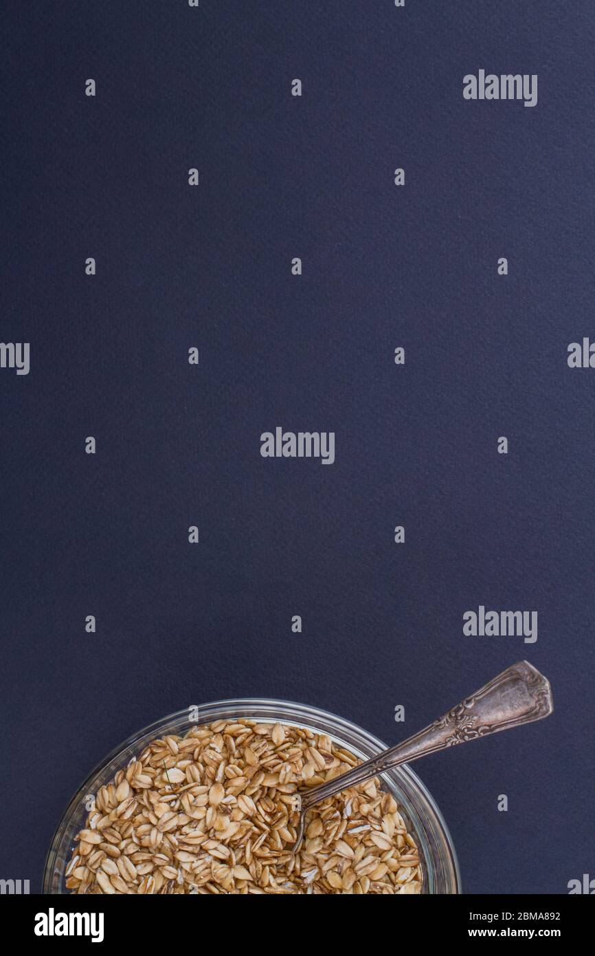 Plate of dry oatmeal with spoon and copy space Stock Photo - Alamy