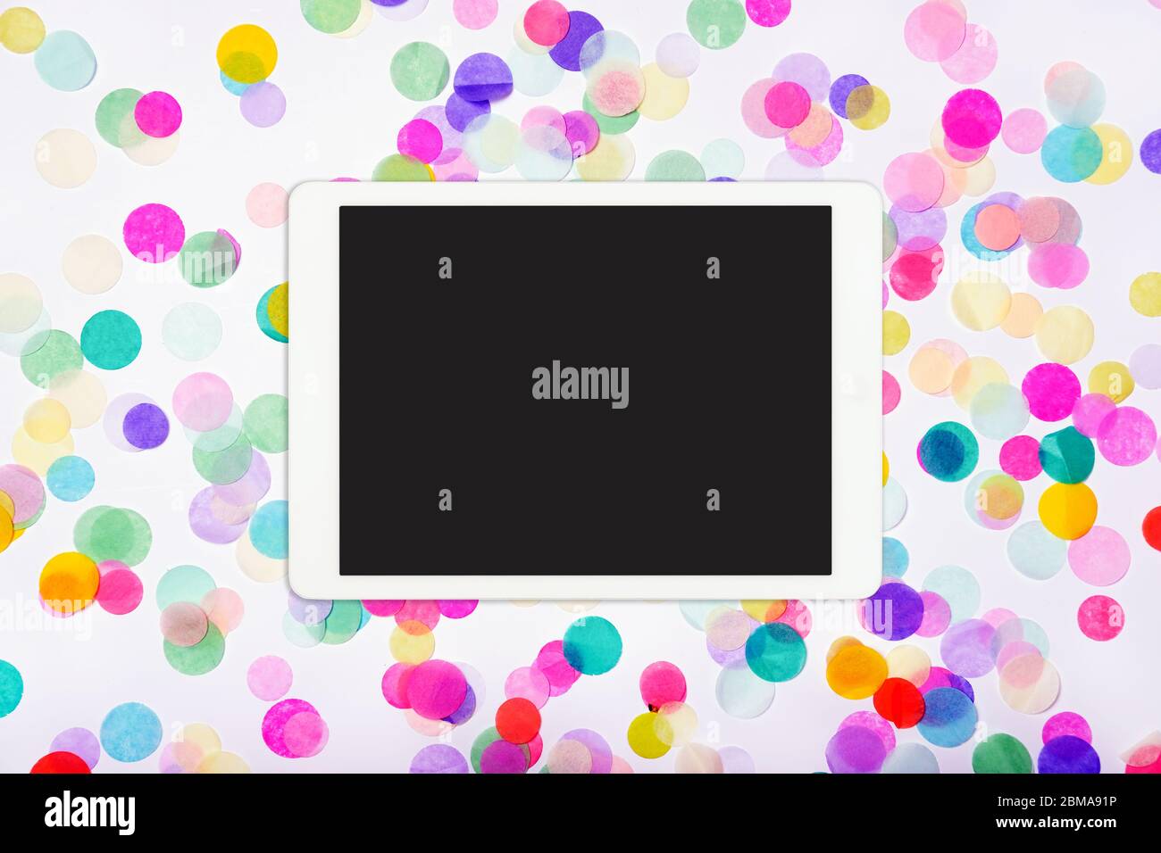 Blank touchscreen display with colorful confetti on white background ...