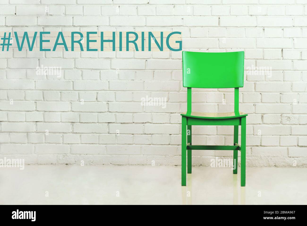 Concept of vacant chair. Green wooden chair against white brick wall ...