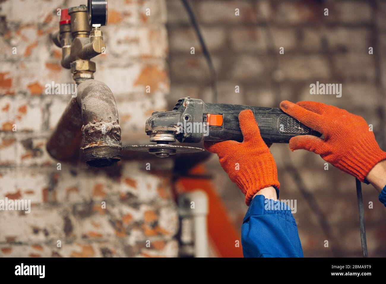 Closeup of repairman in uniform, professional builder working using ...