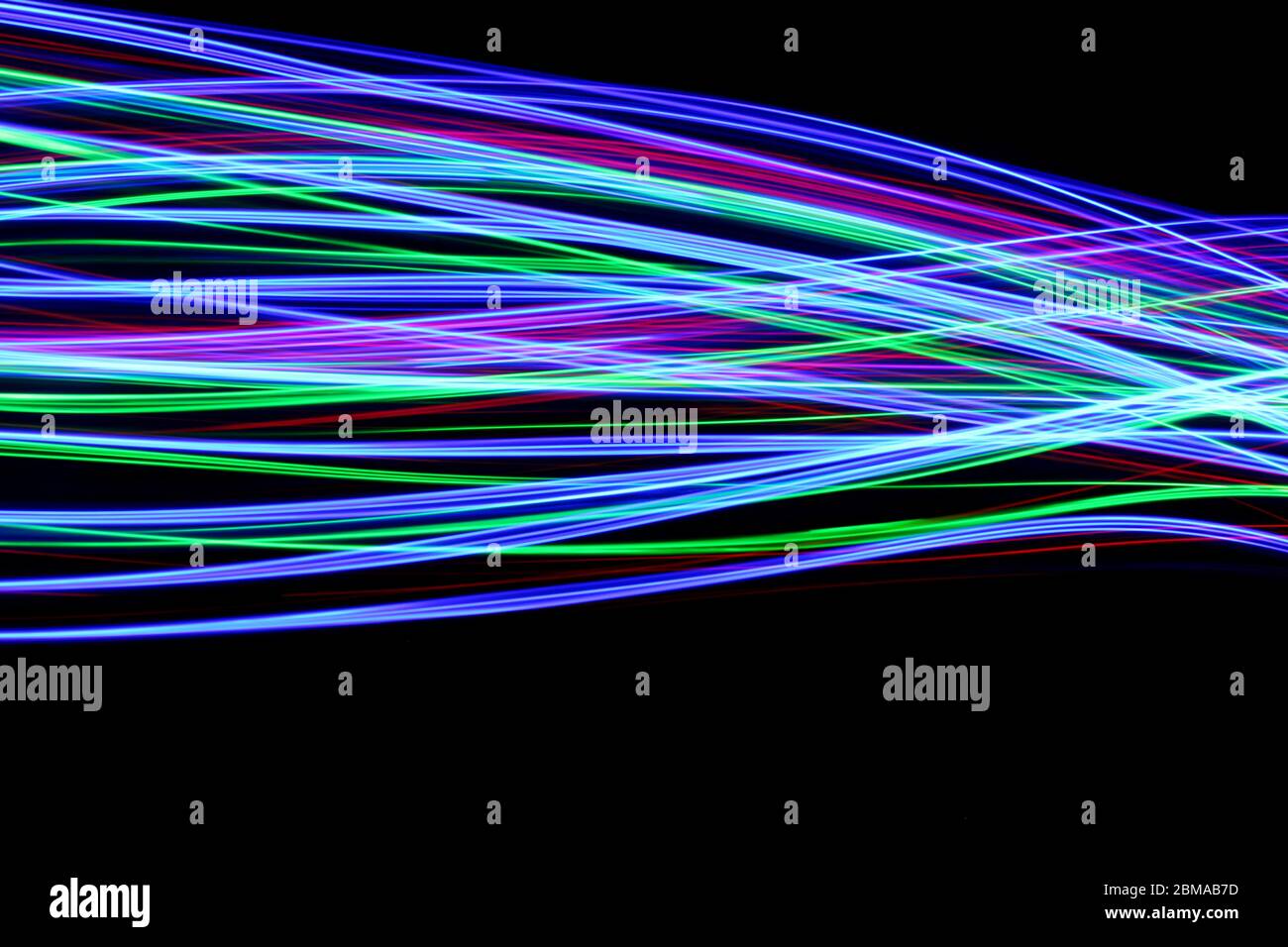 Long exposure photograph of neon colour in an abstract swirl, parallel ...