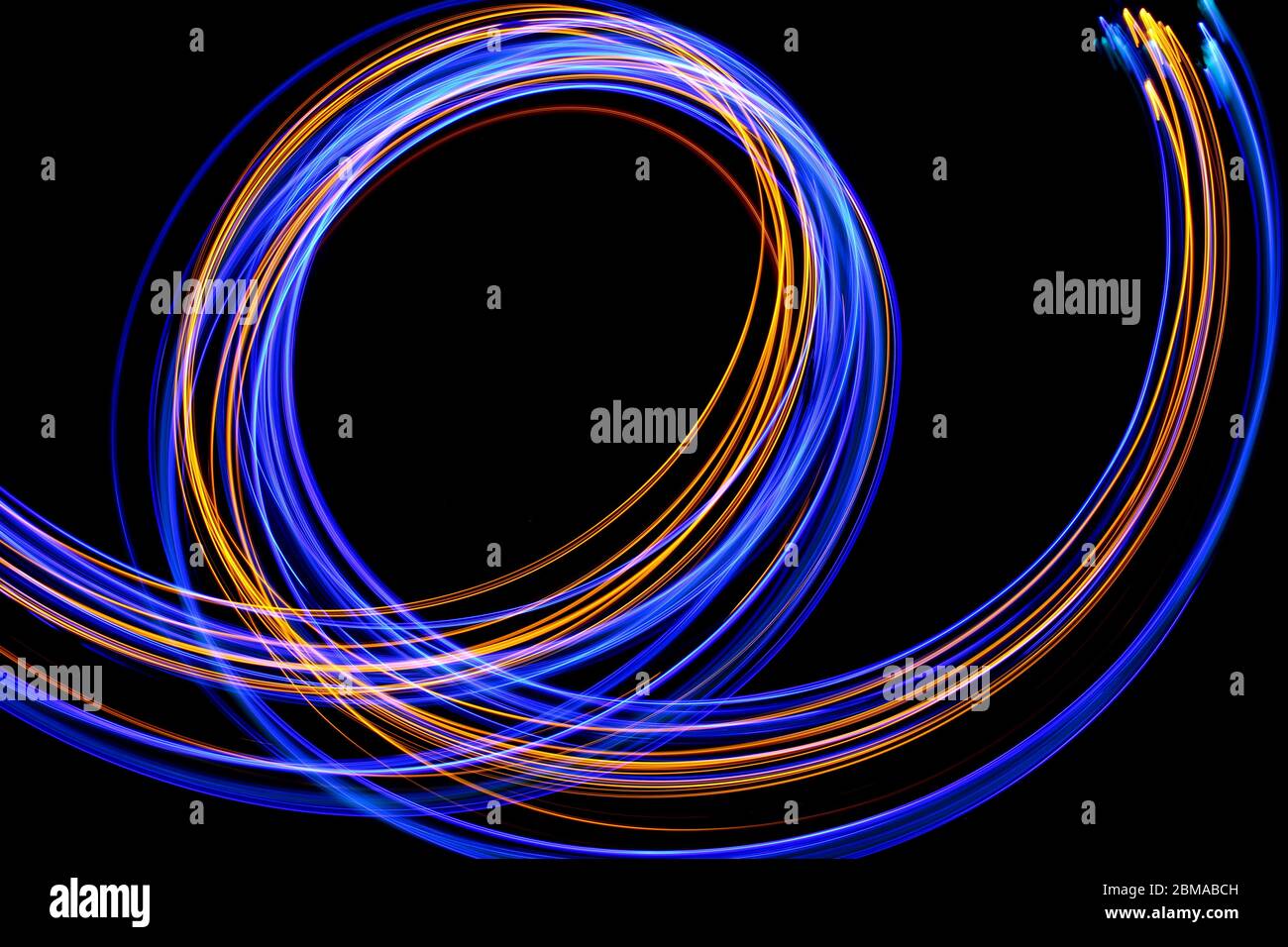 Long exposure photograph of neon colour in an abstract swirl, parallel ...
