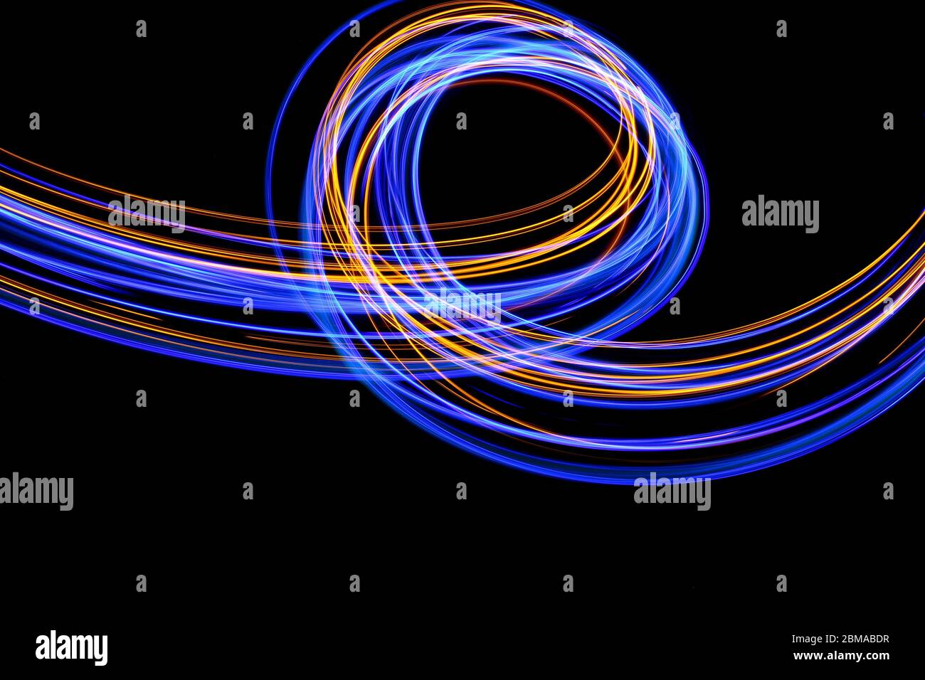 Long exposure photograph of neon colour in an abstract swirl, parallel ...