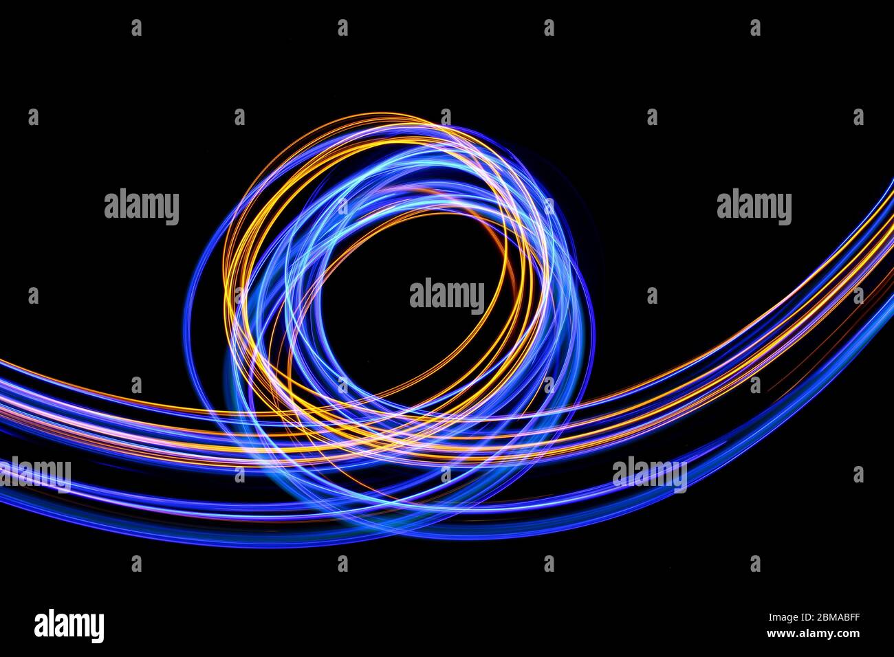 Long exposure photograph of neon colour in an abstract swirl, parallel ...