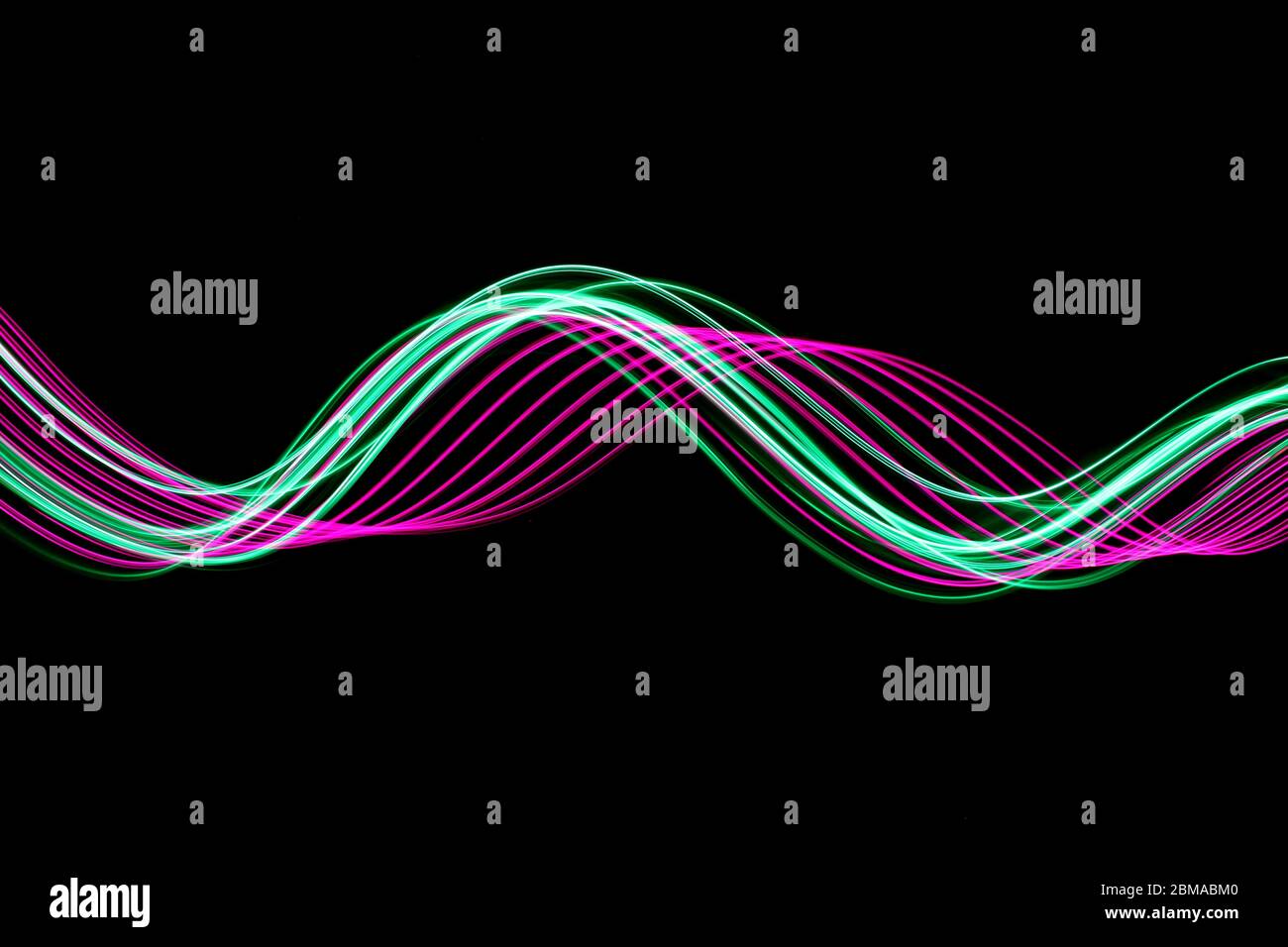 Long exposure photograph of neon colour in an abstract swirl, parallel ...