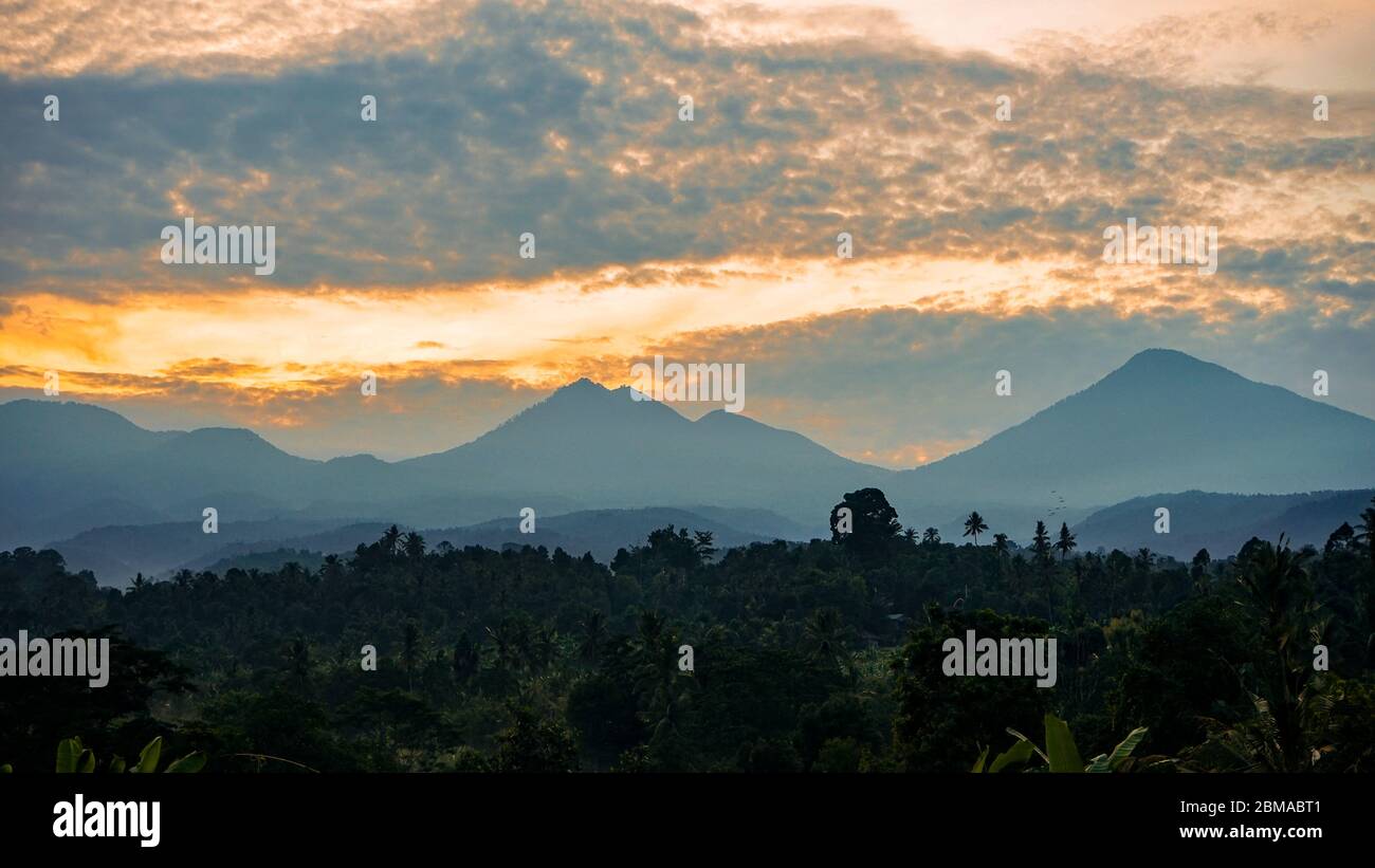 Beautiful views of the sky and two mountains at sunrise Stock Photo - Alamy