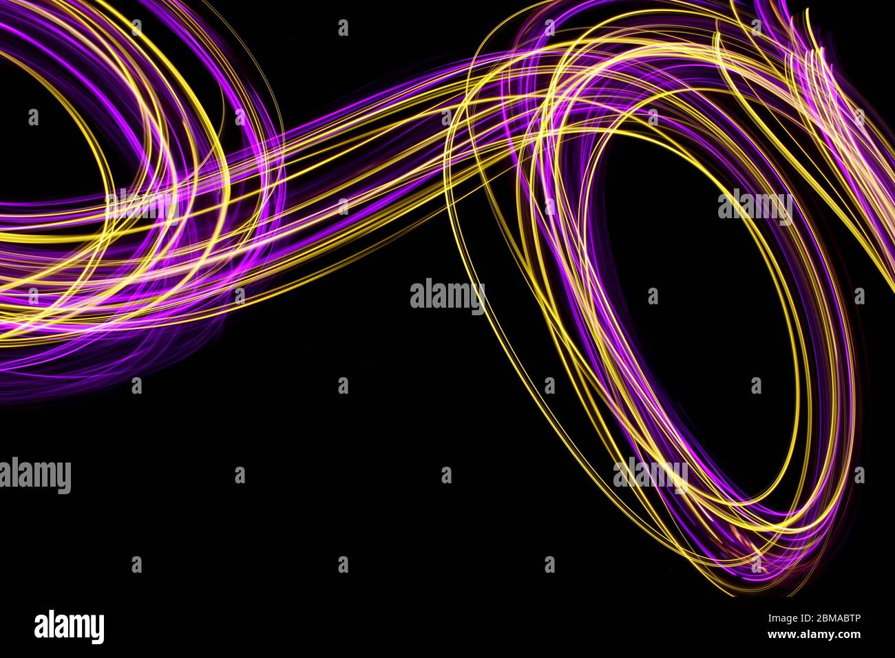 Long exposure photograph of neon colour in an abstract swirl, parallel ...