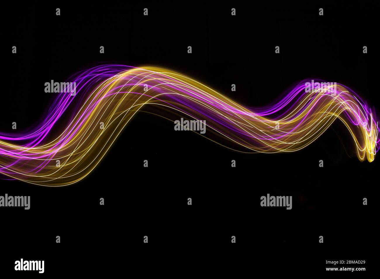 Long exposure photograph of neon colour in an abstract swirl, parallel ...