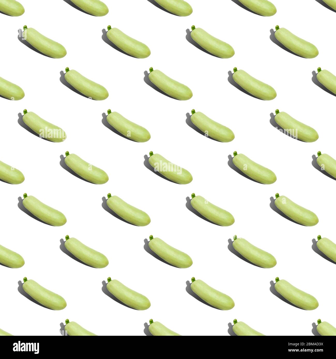 Seamless texture of vegetable zucchini on a white background. Close up ...