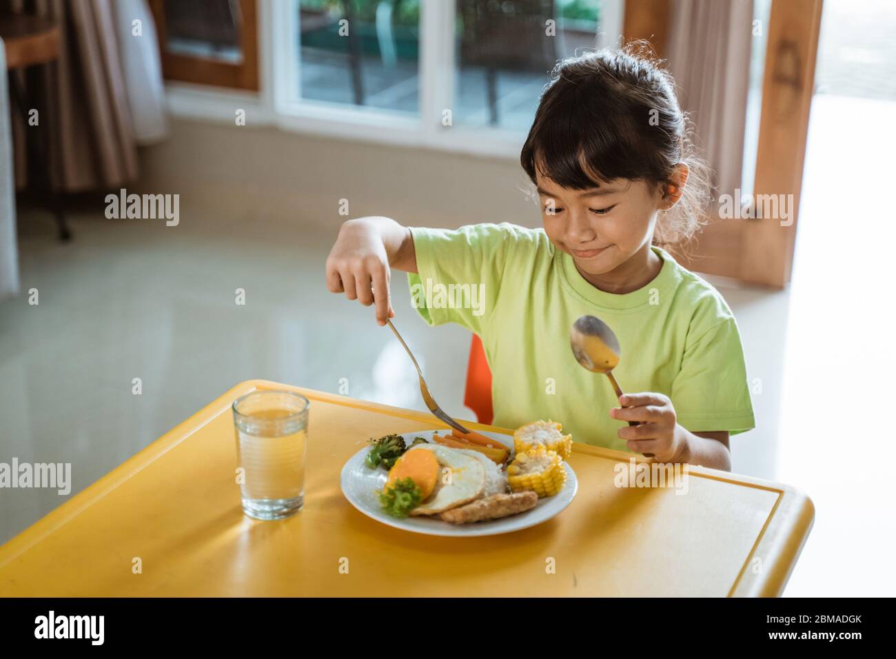 independent kid self eating at home having some breakfast Stock Photo ...