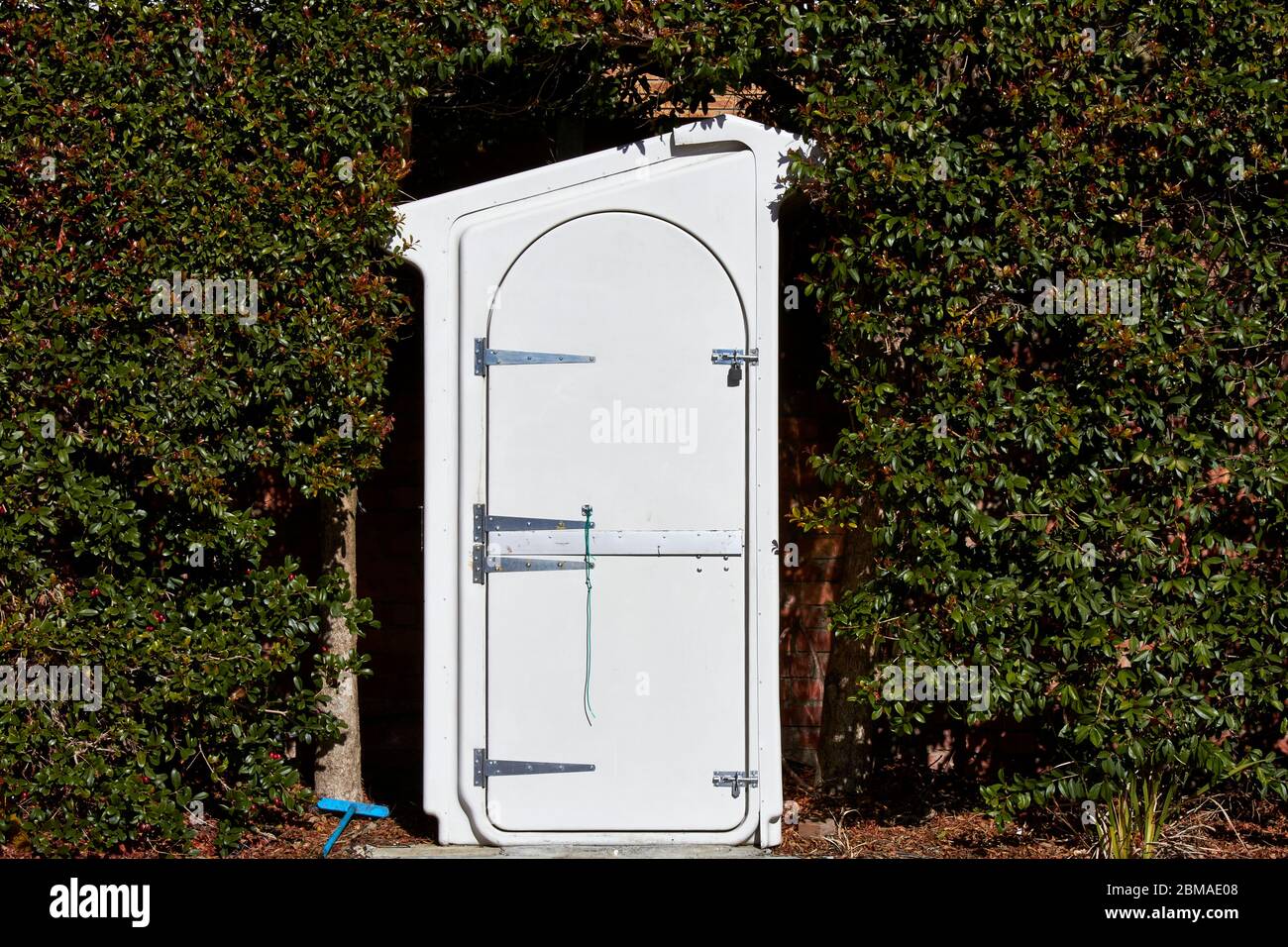 White hut surrounded by green foliage with a closed door. Concept of ...