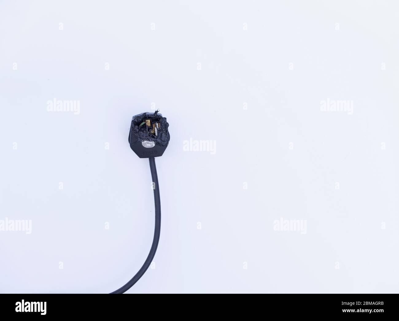 Burnt out electric plug showing fuse with black wire still attached ...